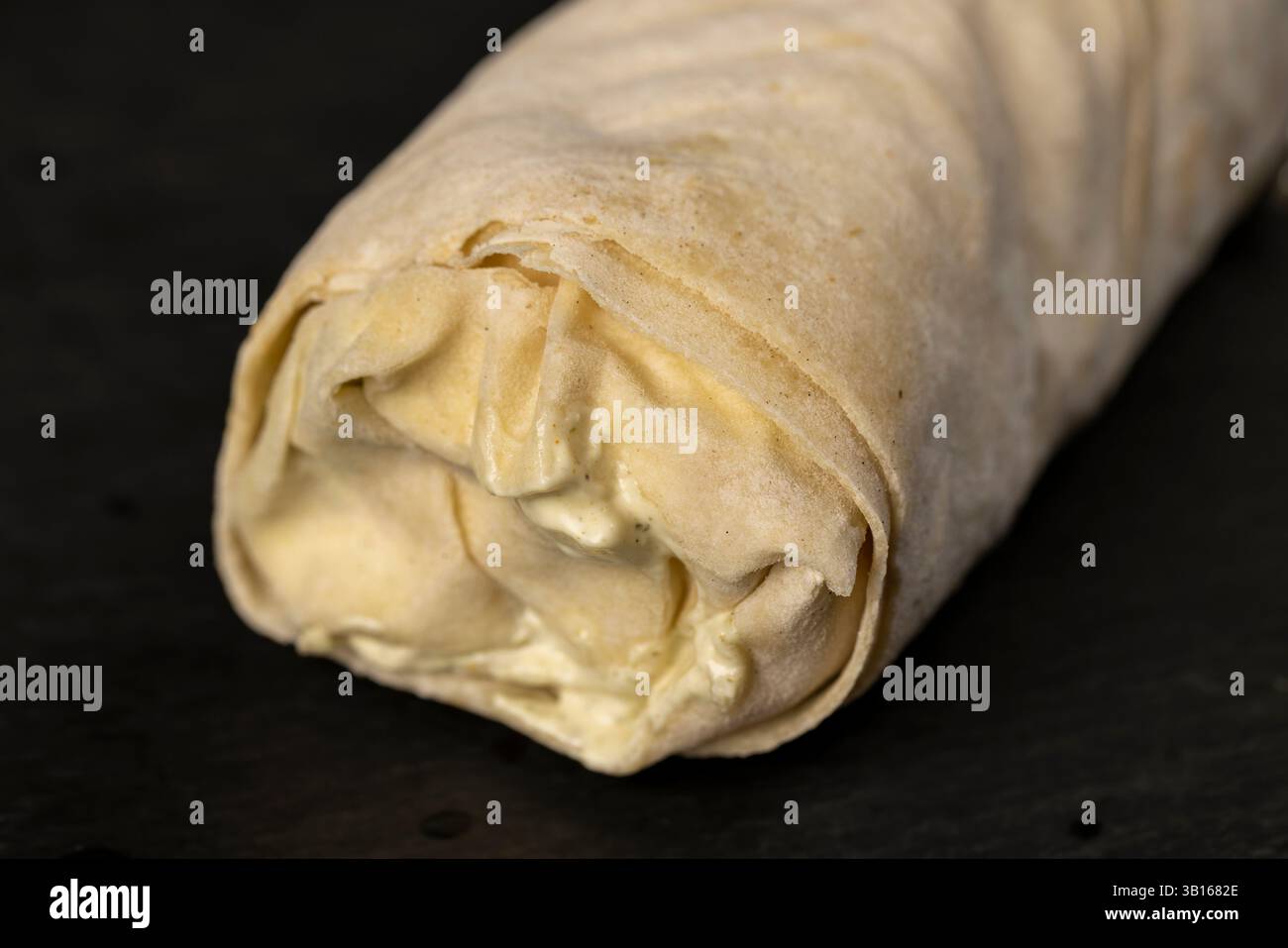 shawarma from thin tortilla with meat with tomatoes and sauce, fast ...