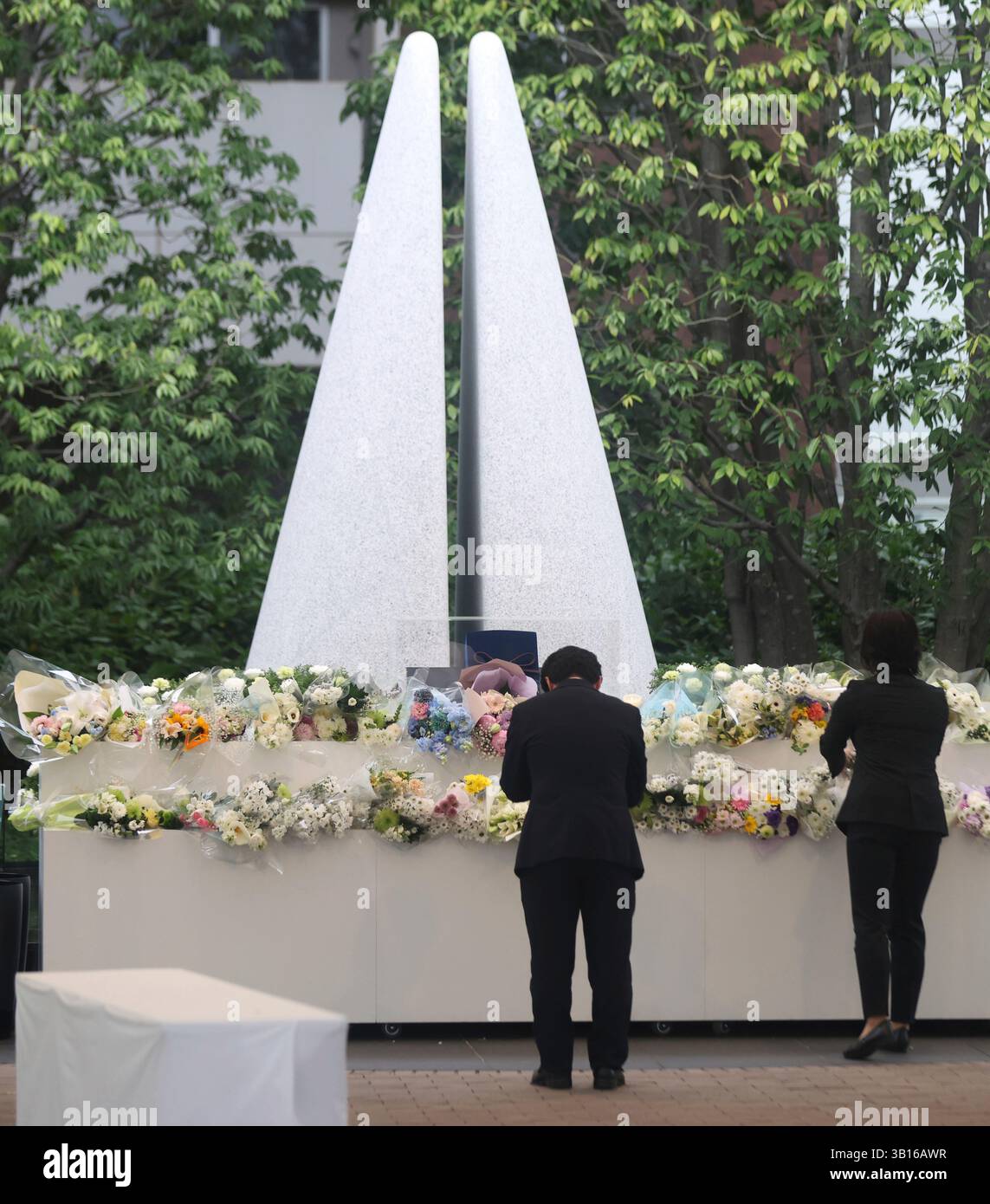 A memorial ceremony for the victims of a train derailment accident is held at the memorial ...
