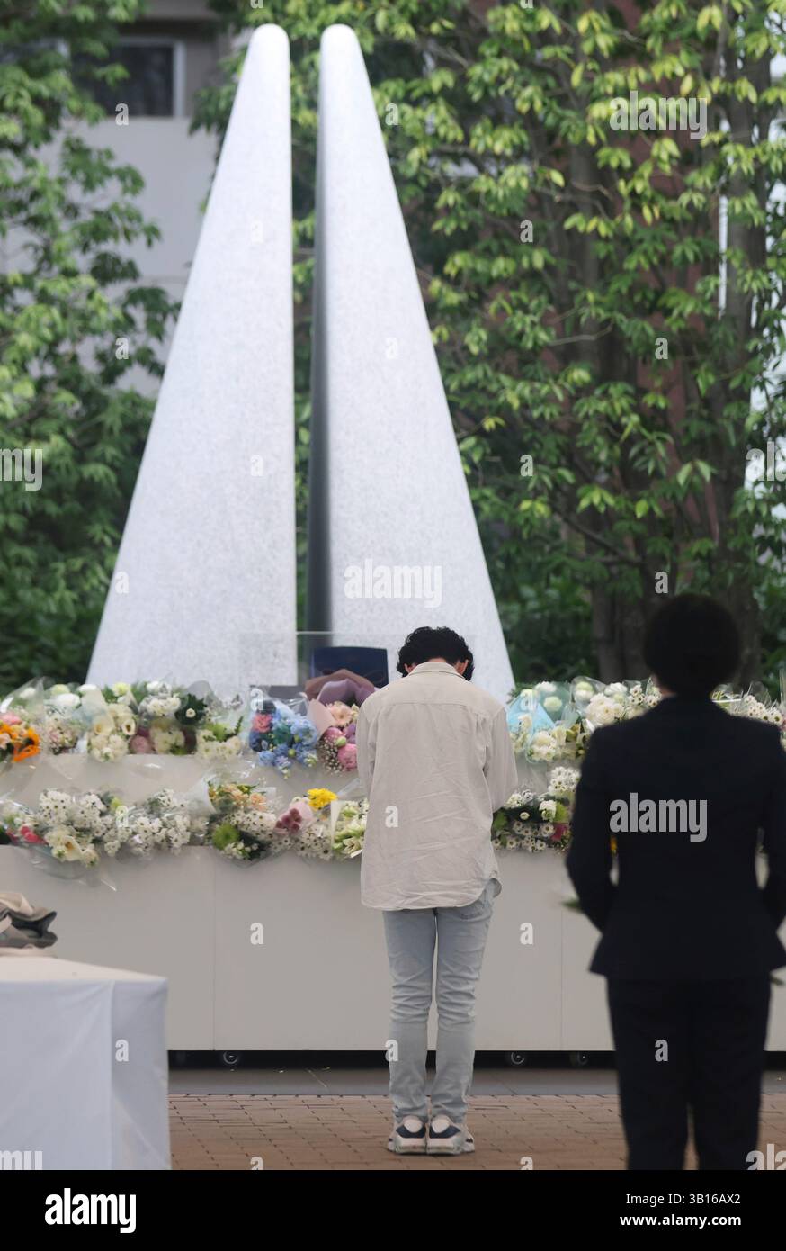A memorial ceremony for the victims of a train derailment accident is held at the memorial ...