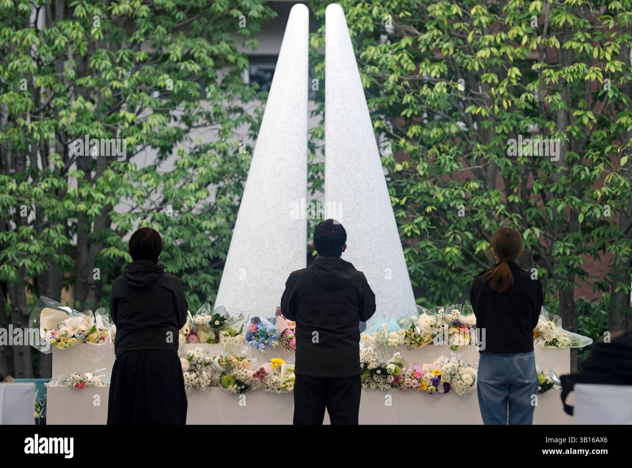 A memorial ceremony for the victims of a train derailment accident is held at the memorial ...