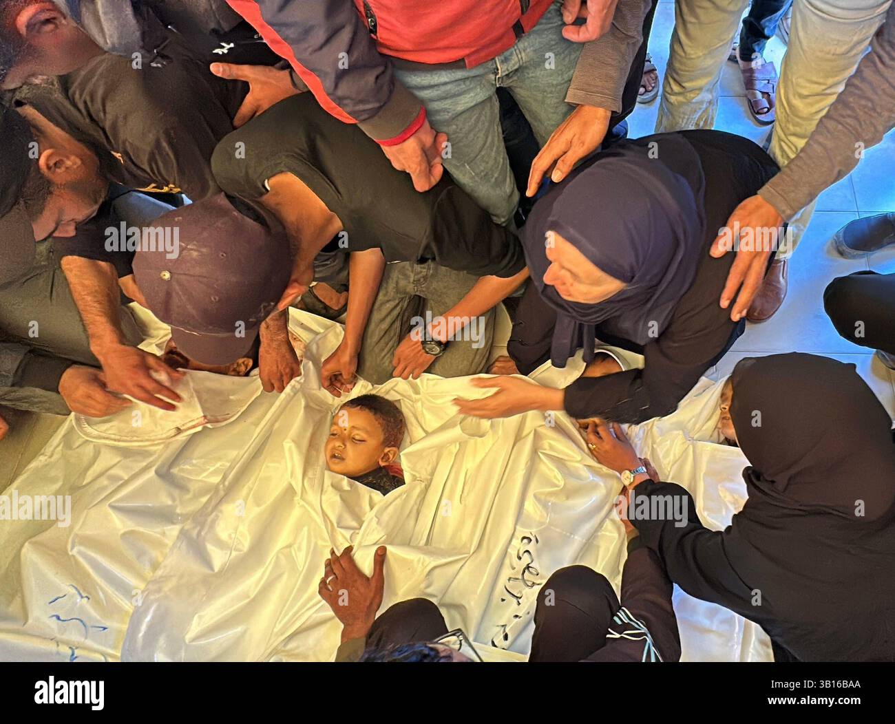Palestinians gather next to the bodies of Abu Taima family killed in ...