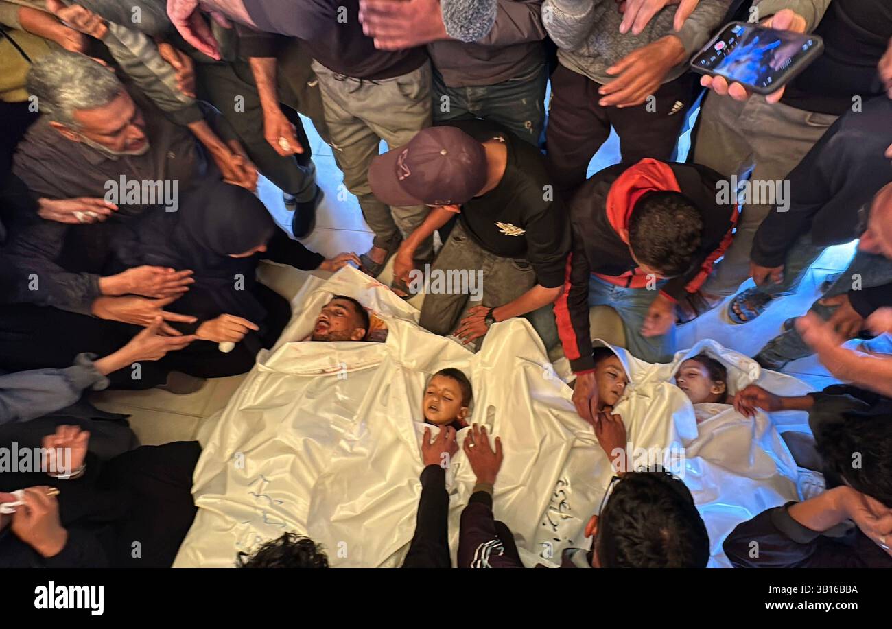Palestinians gather next to the bodies of Abu Taima family killed in ...