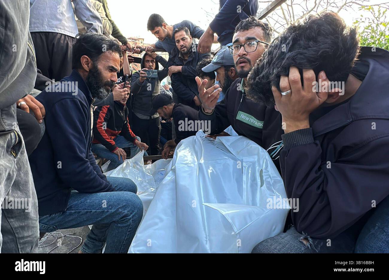 Palestinians gather next to the bodies of Abu Taima family killed in ...