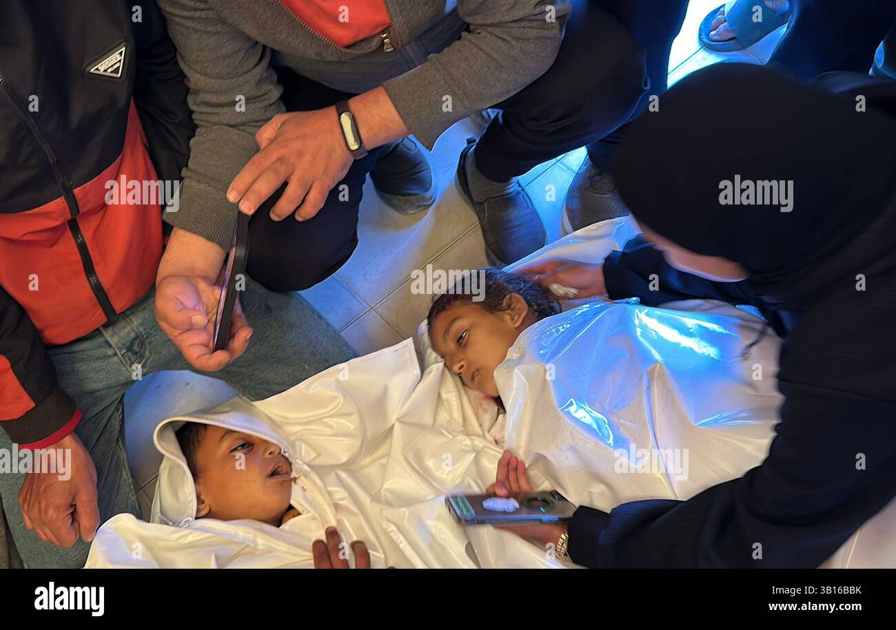 Palestinians gather next to the bodies of Abu Taima family killed in ...