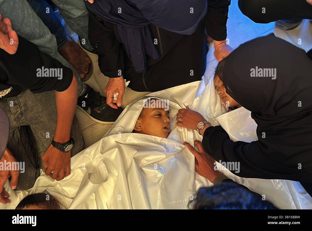 Palestinians gather next to the bodies of Abu Taima family killed in ...