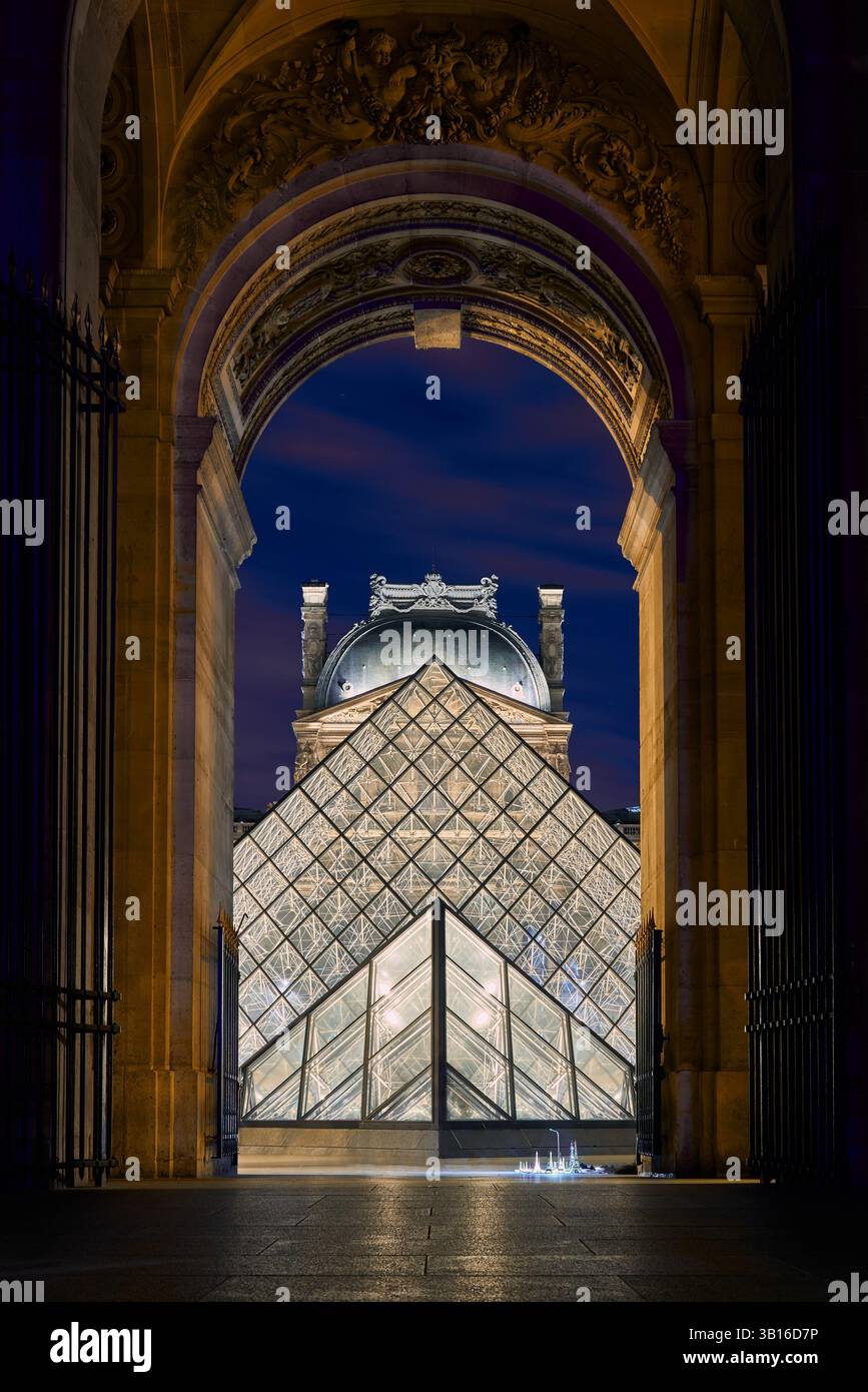 illuminated pyramid of Louvre Palace Art Museum in Paris France is a ...