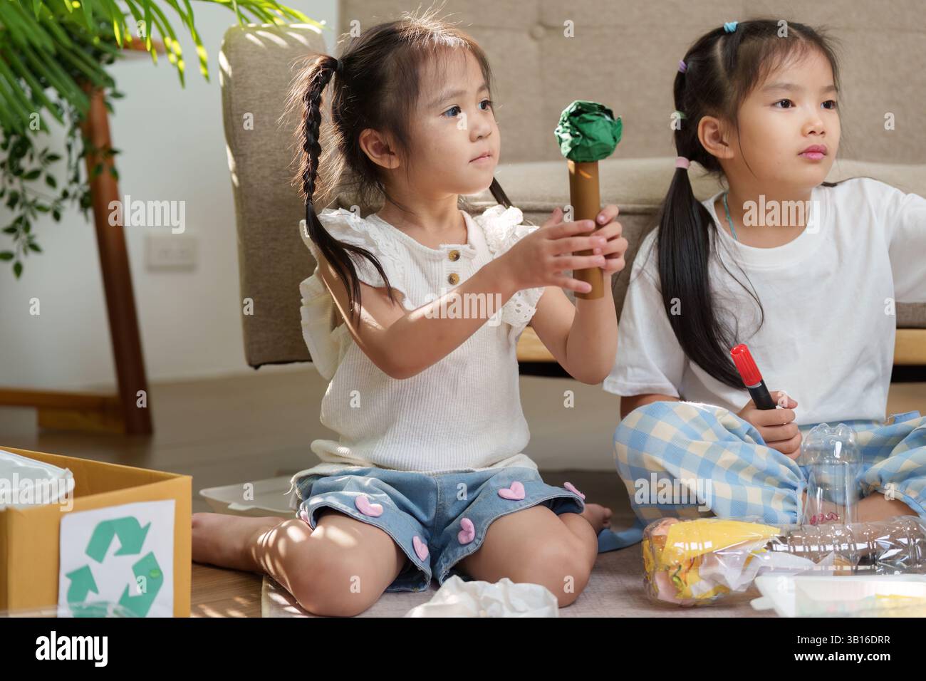 Eco-Friendly Crafts and Family Bonding. Two girls proudly displaying ...