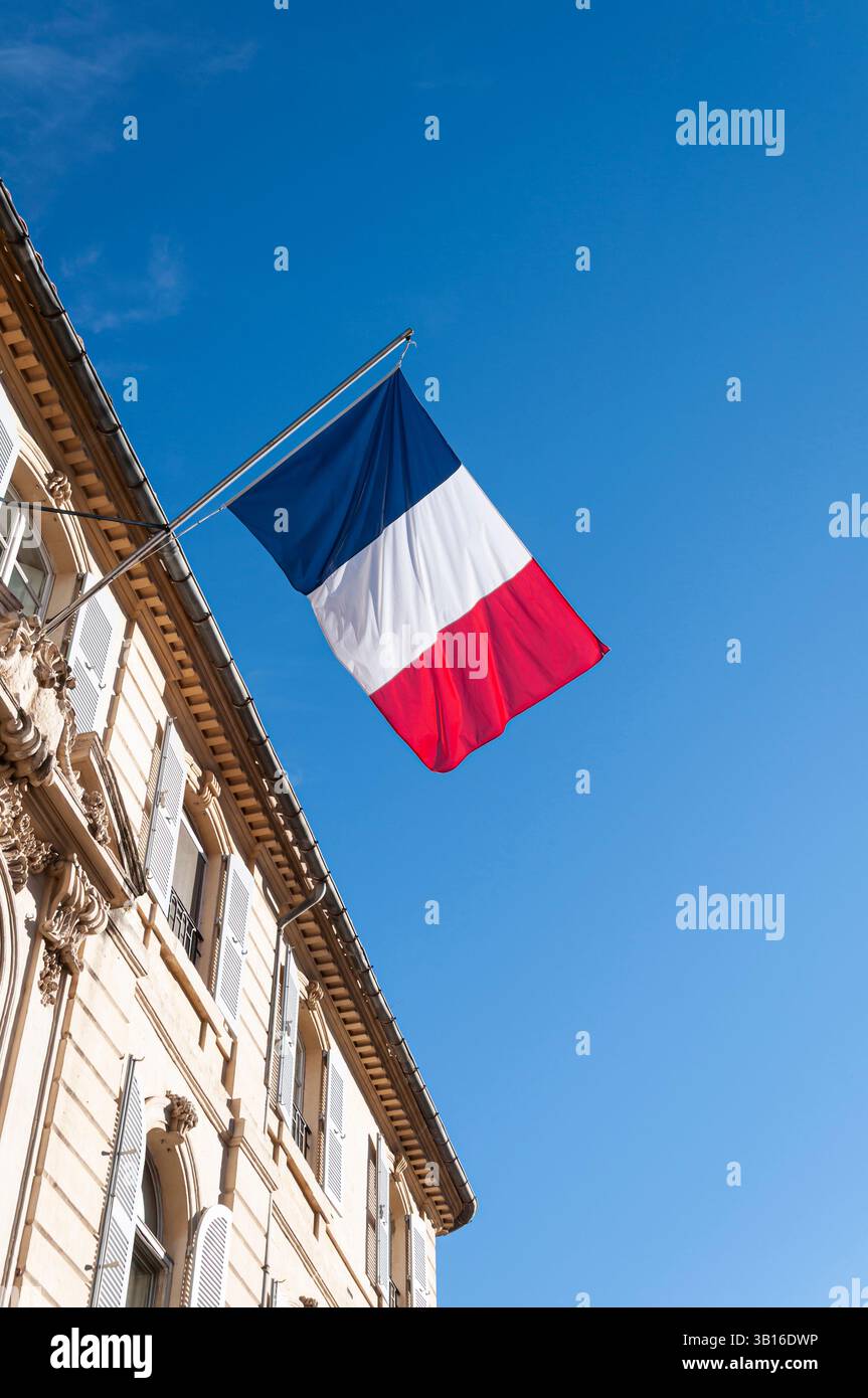 French flag flying at flagpole blue sky background, Arles, Bouches du ...