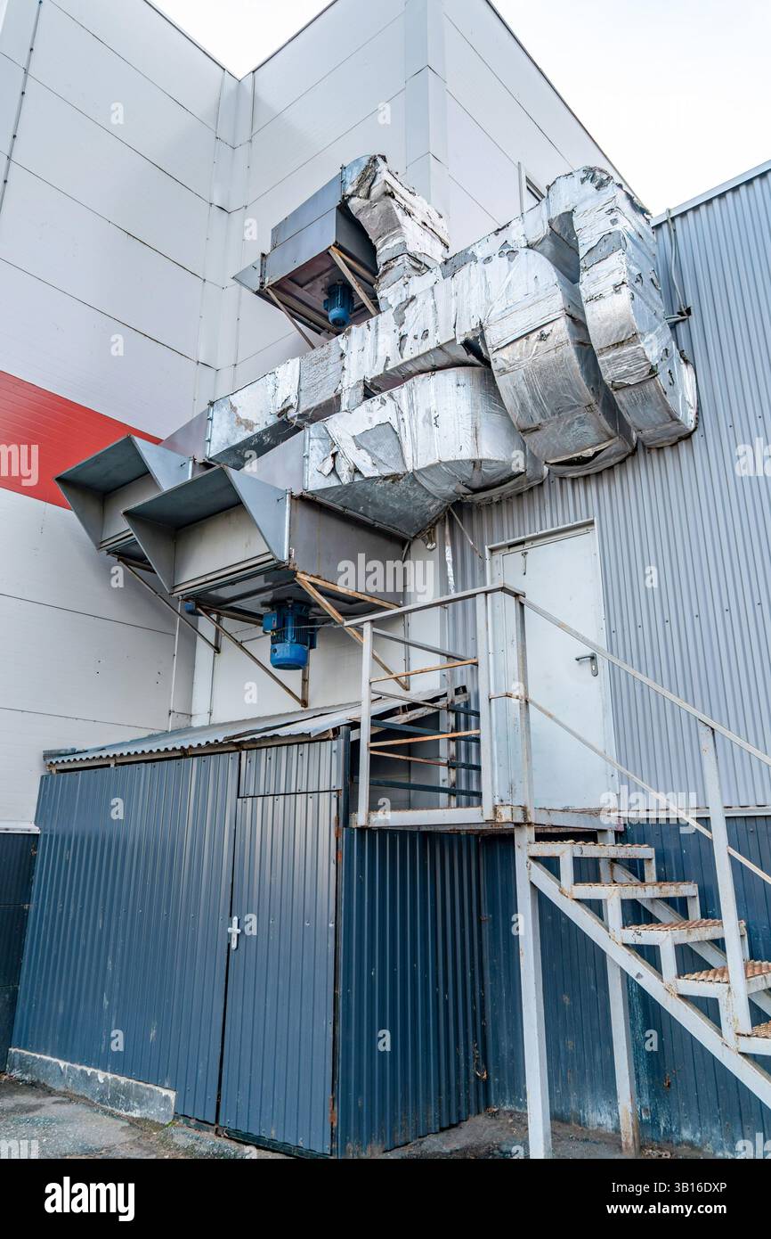 Large insulated ventilation ducts and industrial fans attached to a ...