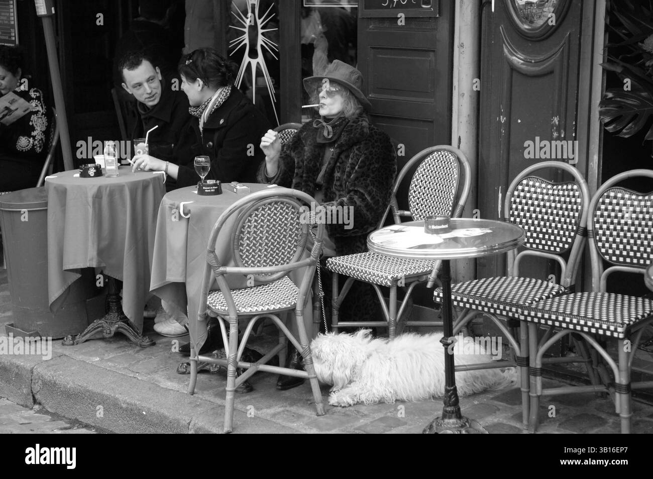 Woman smoking a cigarette outside a cafe in Montmartre, Paris, France ...
