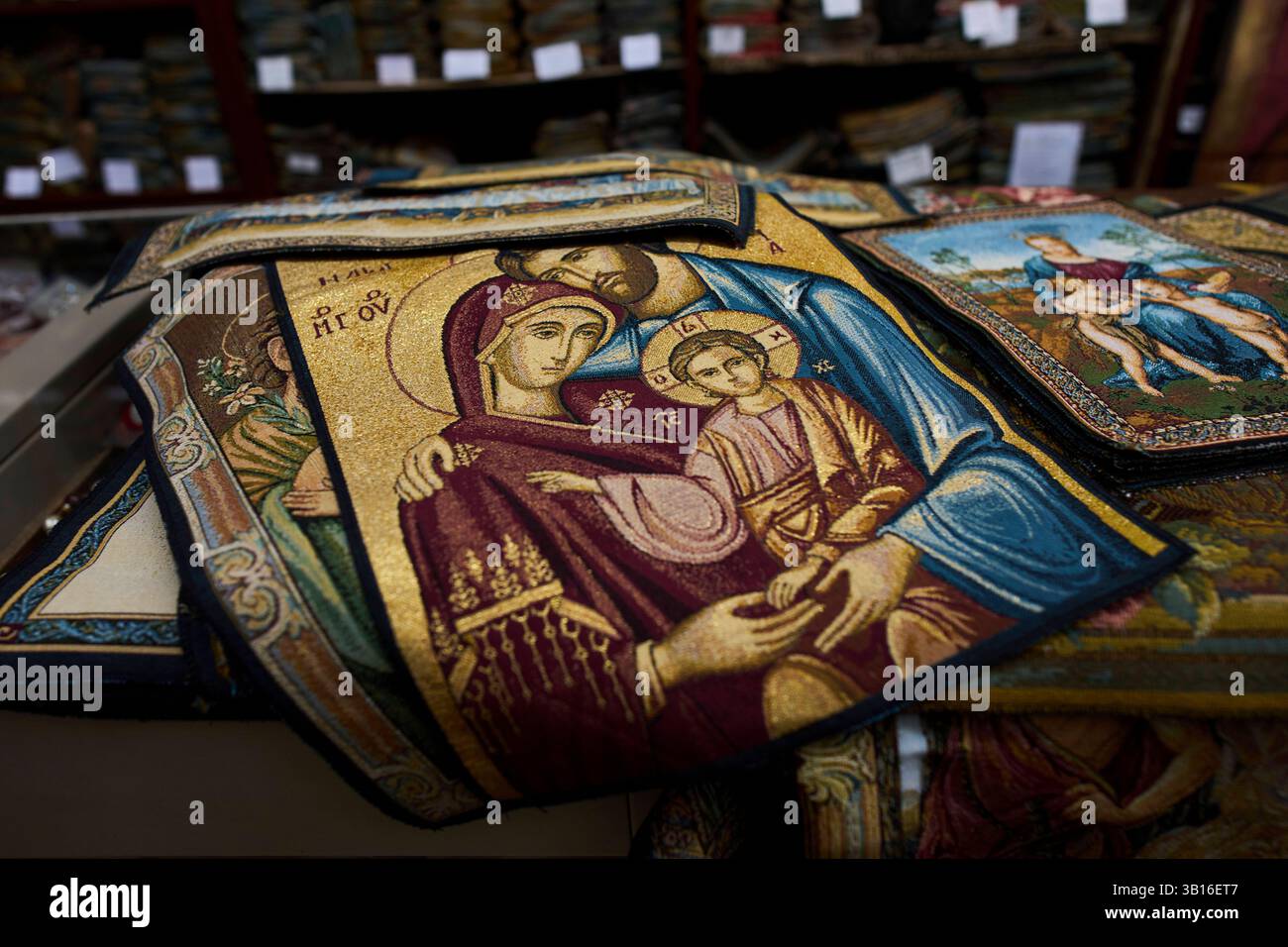 A religious tapestry is displayed in a shop as Pope Francis is lying in ...