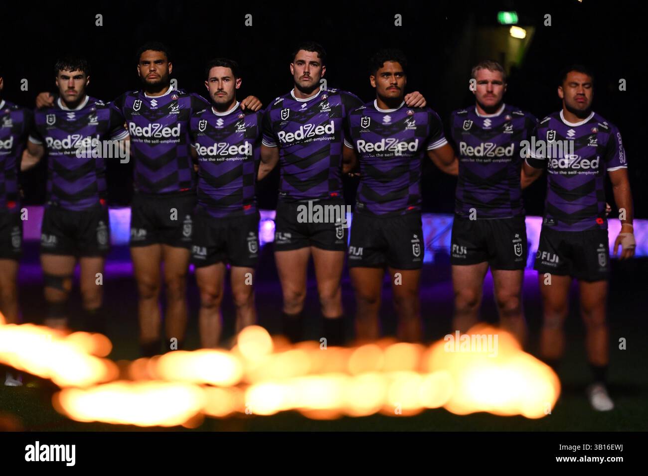 Melbourne Storm players look on as the Anzac ceremony takes place ahead ...