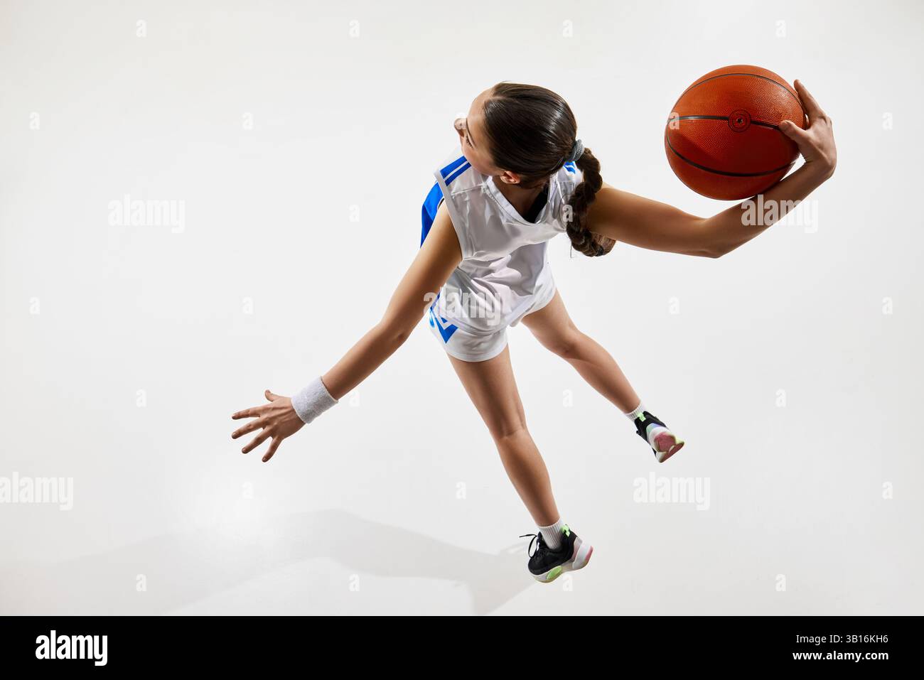 Photo in motion of young athletic girl dressed blue basketball uniform ...