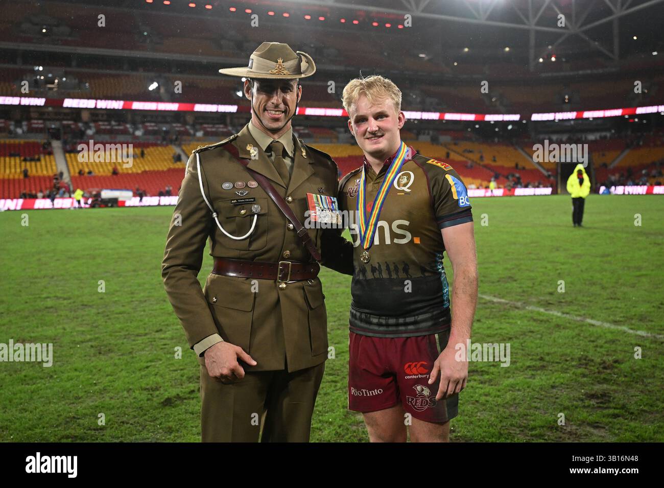 Tom Lynagh of the Reds poses for a photograph after being presented ...