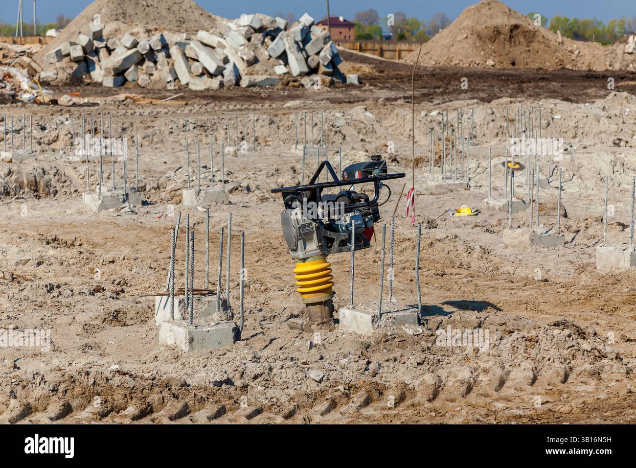 Building site with exposed concrete footings, vertical steel ...