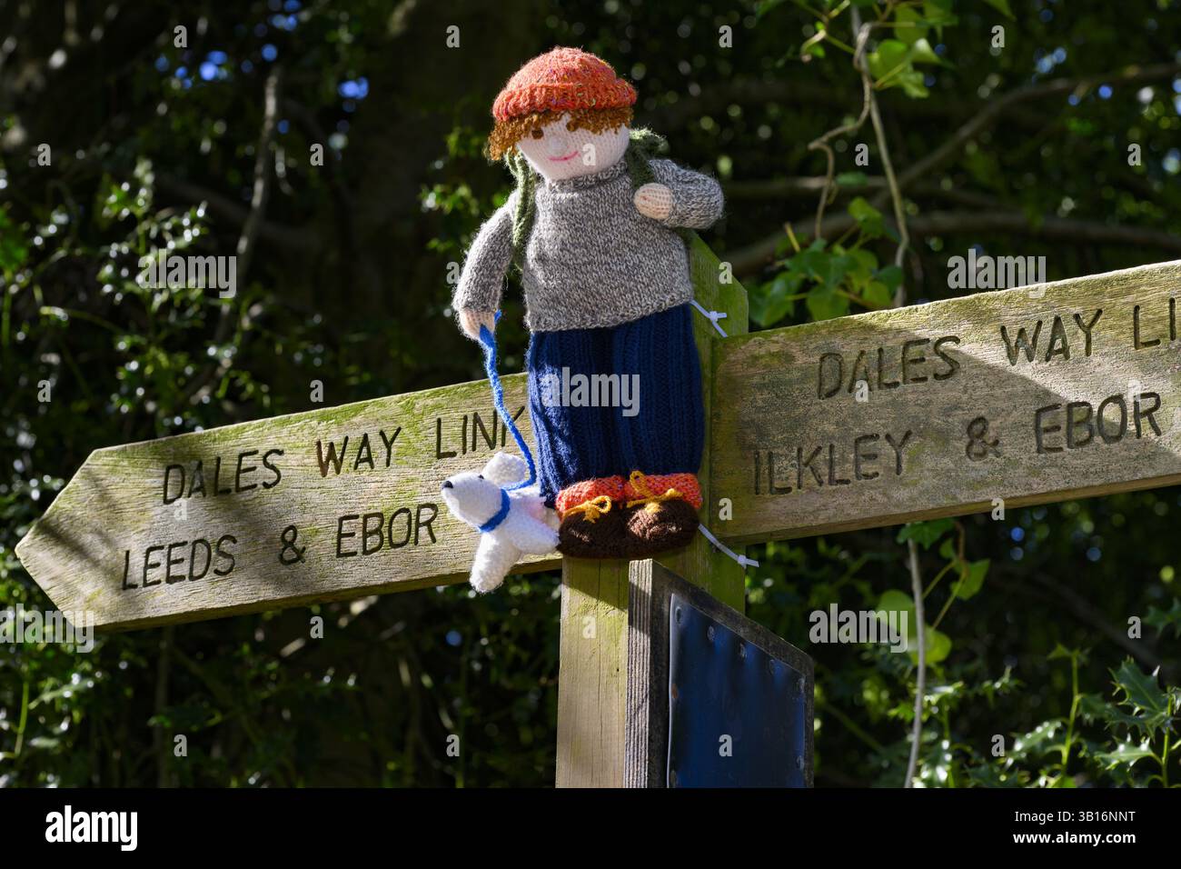 Yarnbomb person attached to fingerpost (long-distance public footpath ...