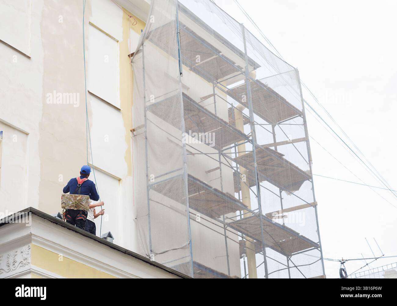 Worker at height on a building construction site Stock Photo - Alamy