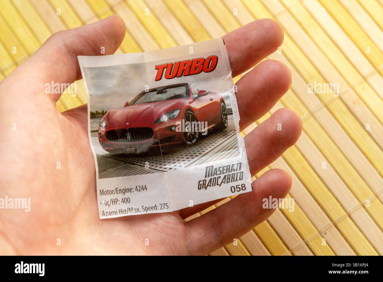 Vintage Turbo chewing gum car collectible card held in hand with a red ...