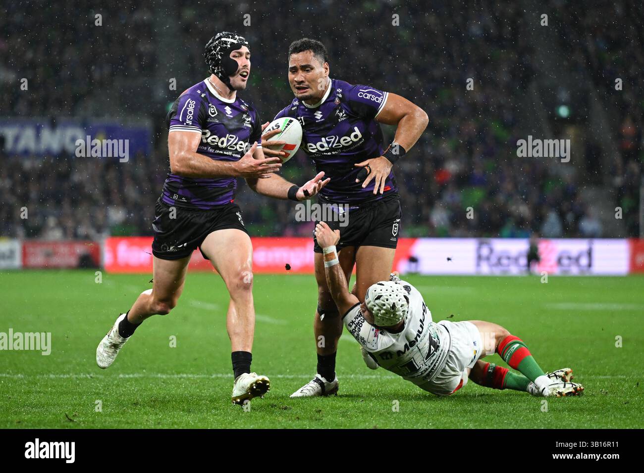 Eliesa Katoa of the Storm (centre) is tackled by Jye Gray of the ...