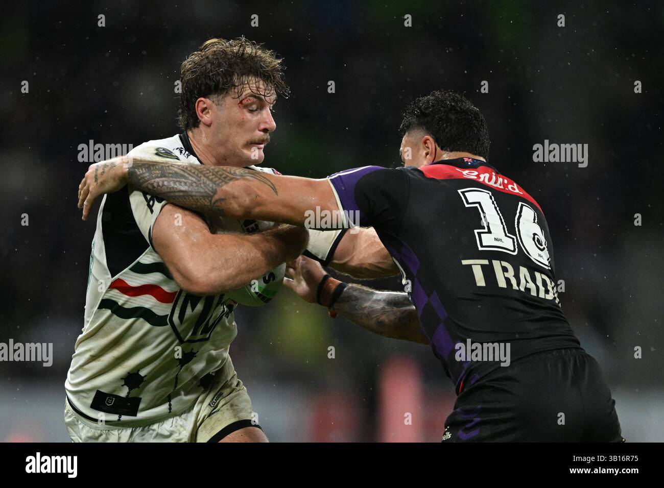 Campbell Graham of the Rabbitohs (left) is tackled by Joe Chan of the ...