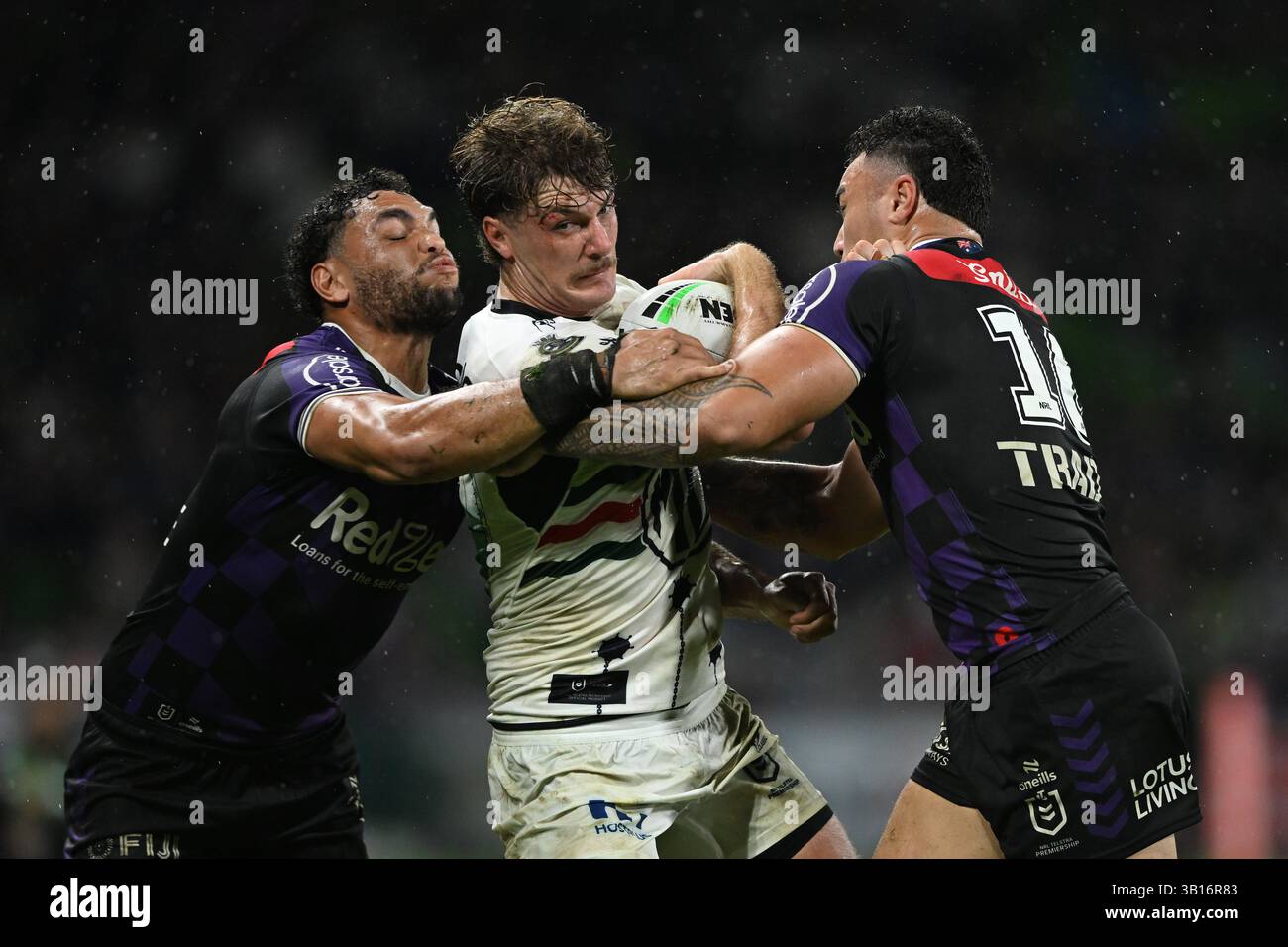 Campbell Graham of the Rabbitohs (left) is tackled by Xavier Coates of ...