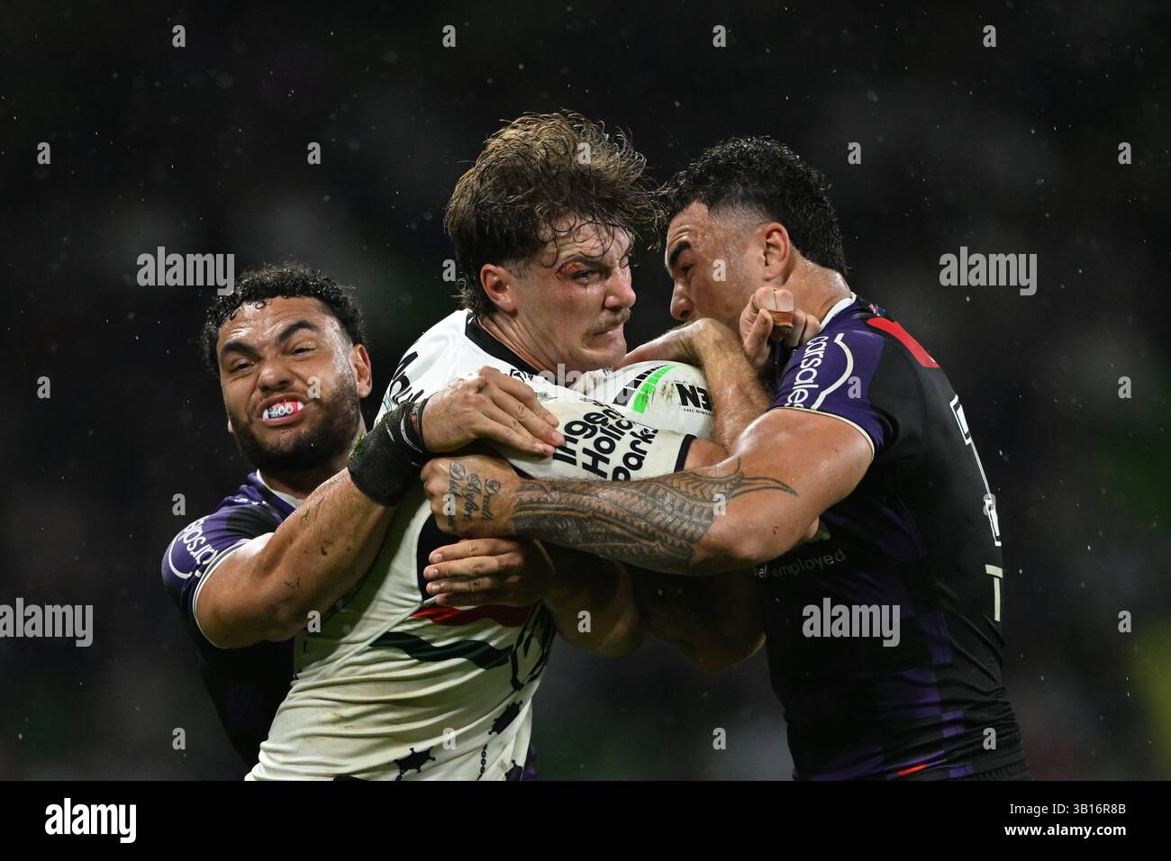 Campbell Graham of the Rabbitohs (left) is tackled by Xavier Coates of ...