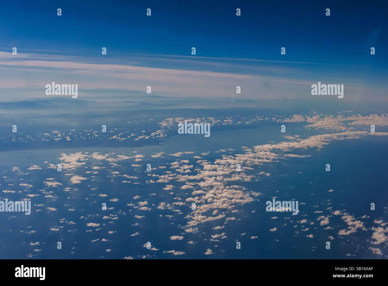 Aerial view from airplane window above green ground. View from the ...