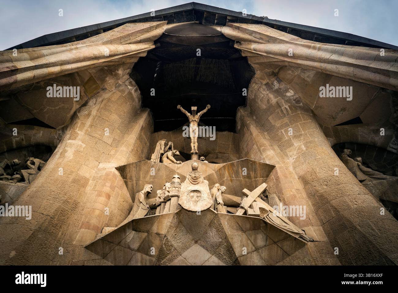 A dramatic view of a stone sculpture depicting religious figures ...