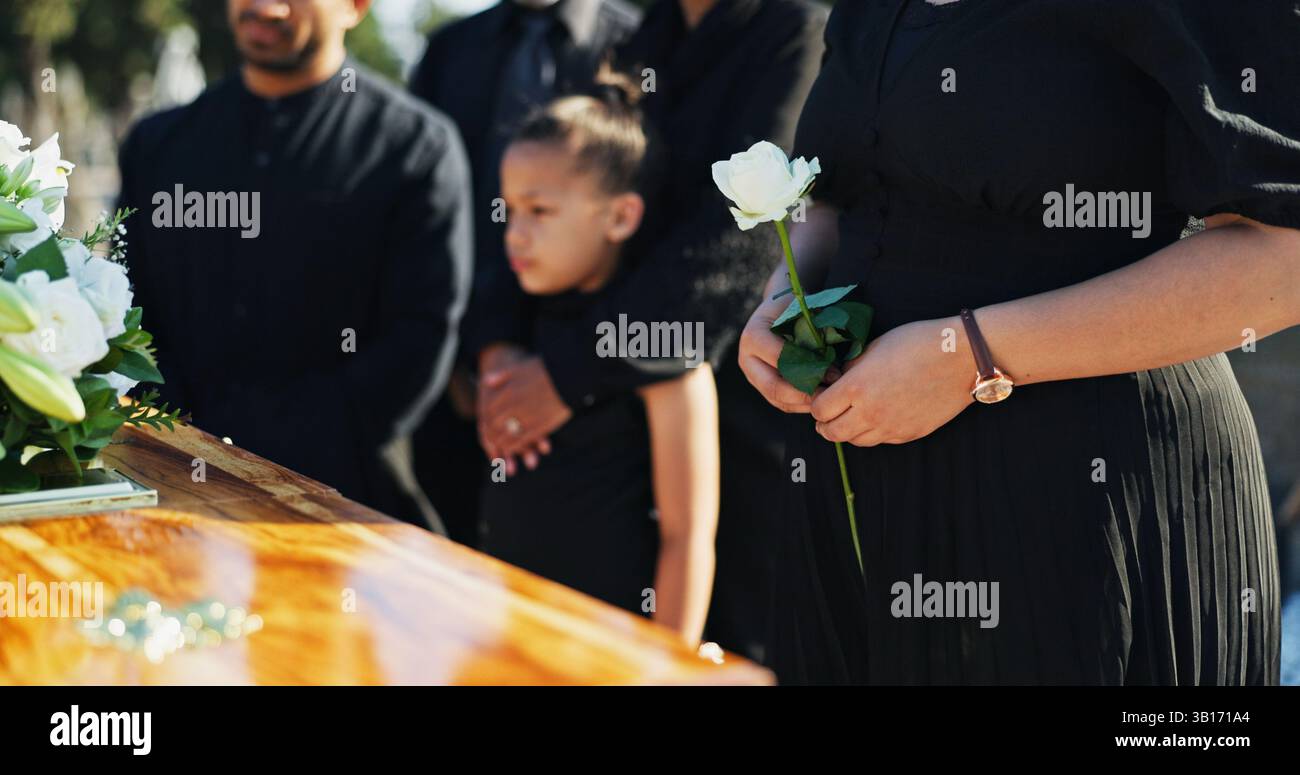 Hand, flower and woman by coffin for funeral ceremony, grief and ...