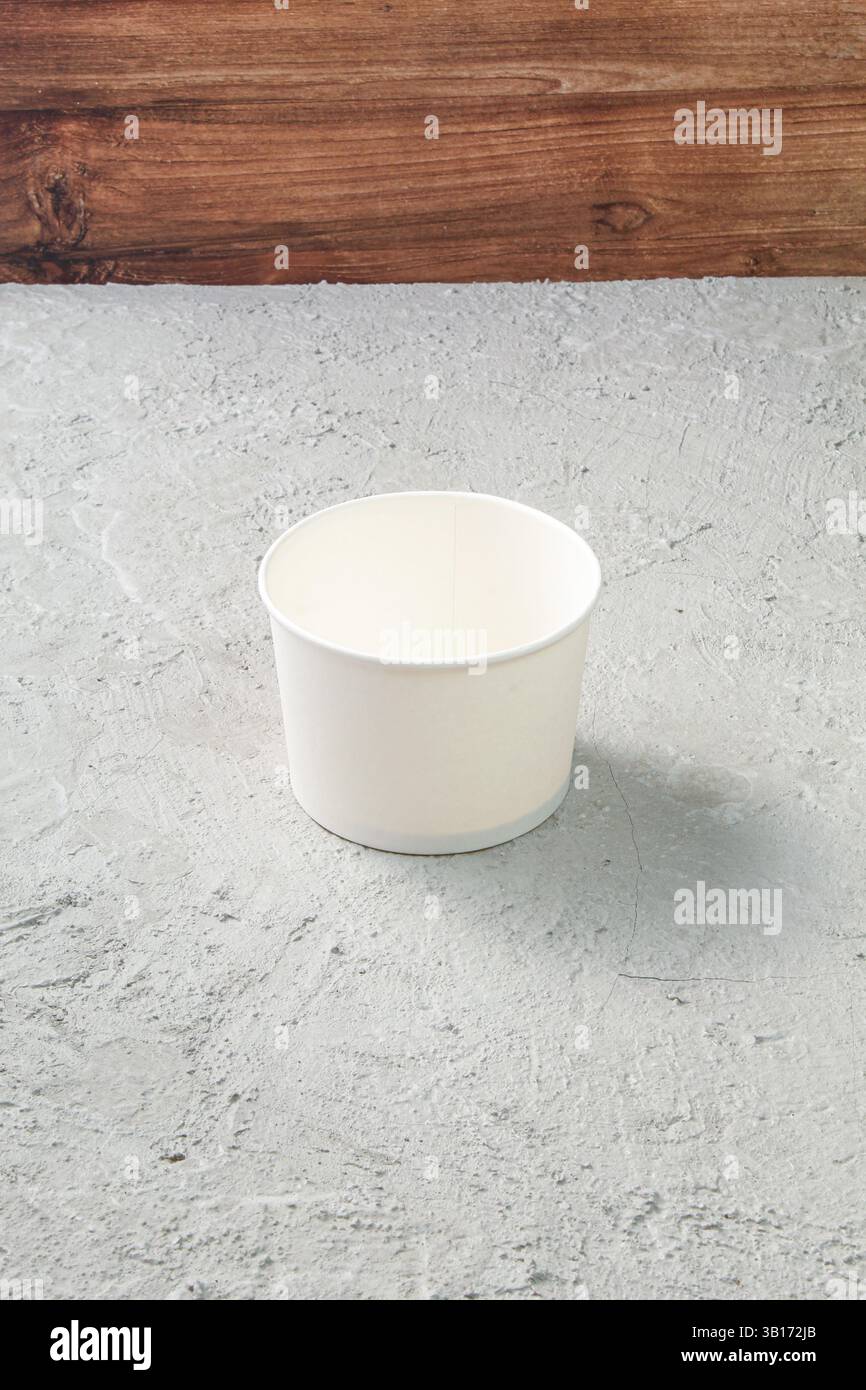 Empty White Paper Bowl on Concrete Textured Table with Wooden ...