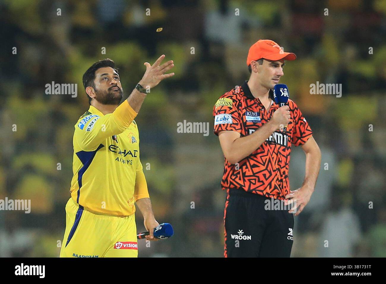 Chennai Super Kings' captain Mahendra Singh Dhoni, left, flips the coin ...