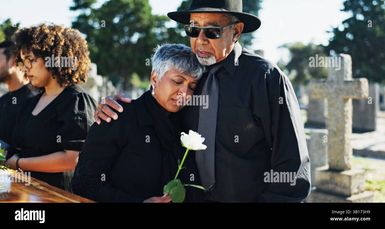 Hug, loss and funeral with people, graveyard and grief with burial ...