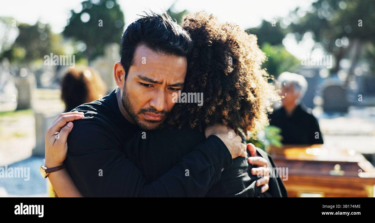 Hug, crying and funeral with people, graveyard and grief with emotion ...