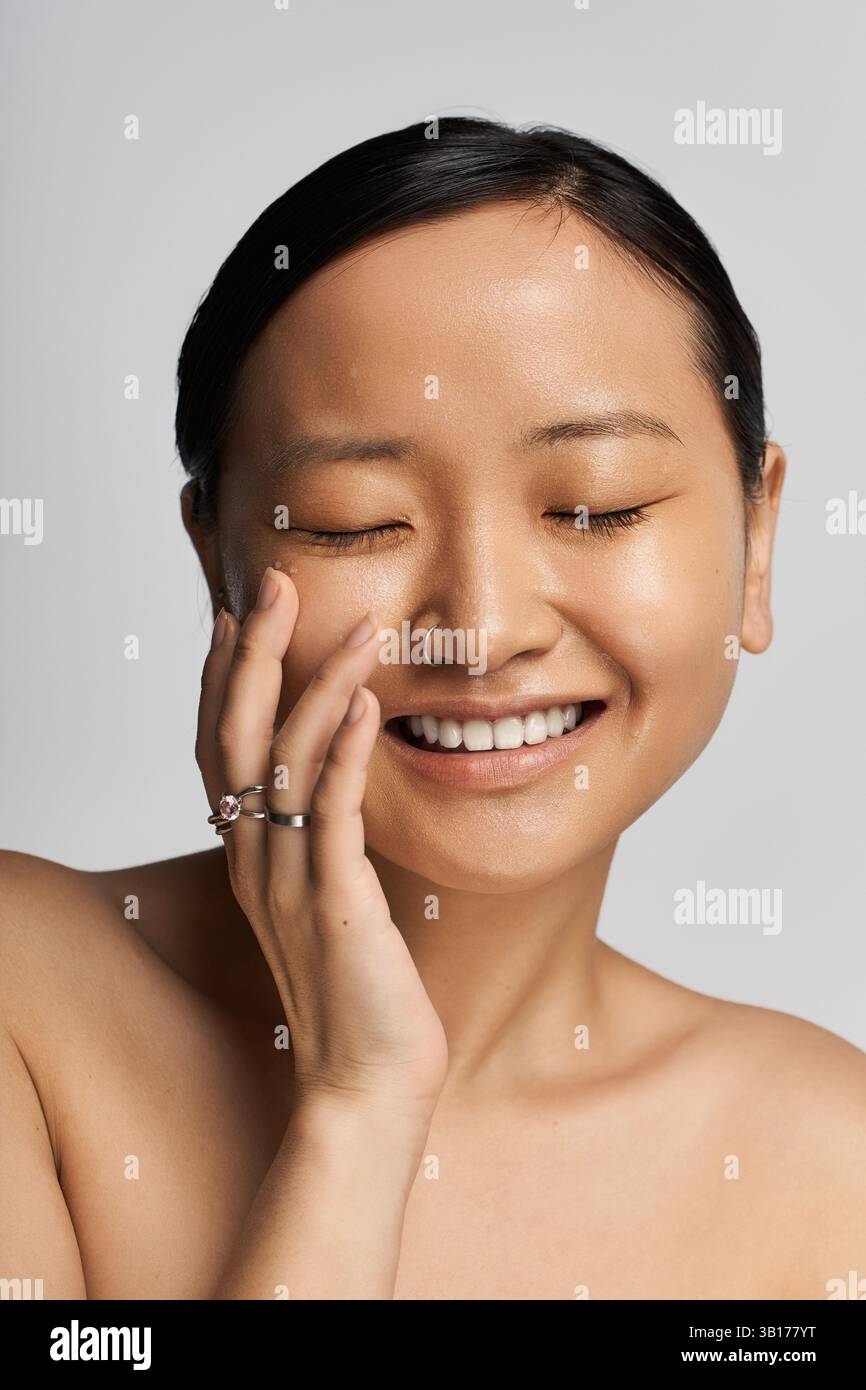 Woman smiles gently touching hi-res stock photography and images - Alamy