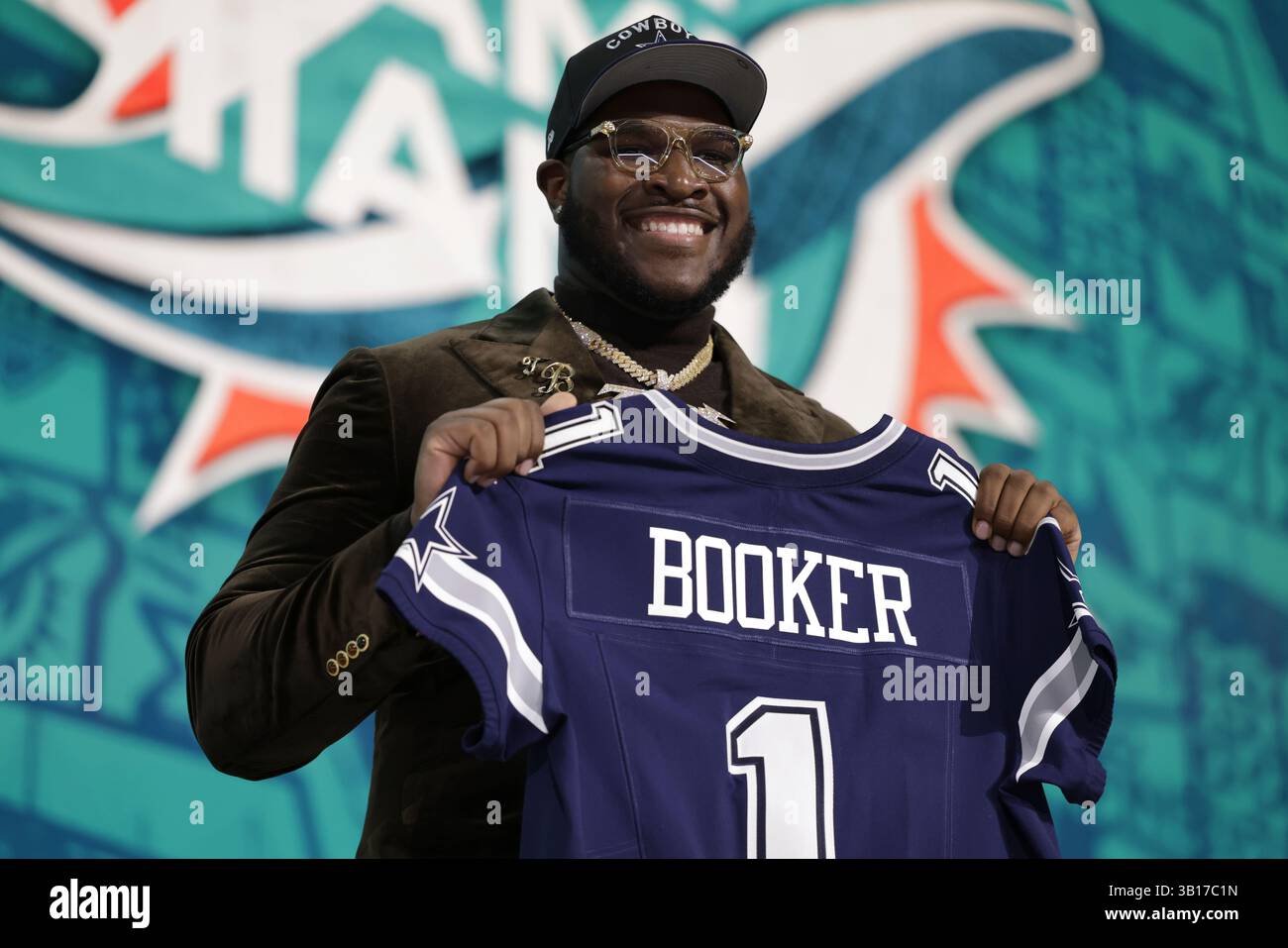 Alabama guard Tyler Booker on stage during the 2025 draft in Green Bay ...