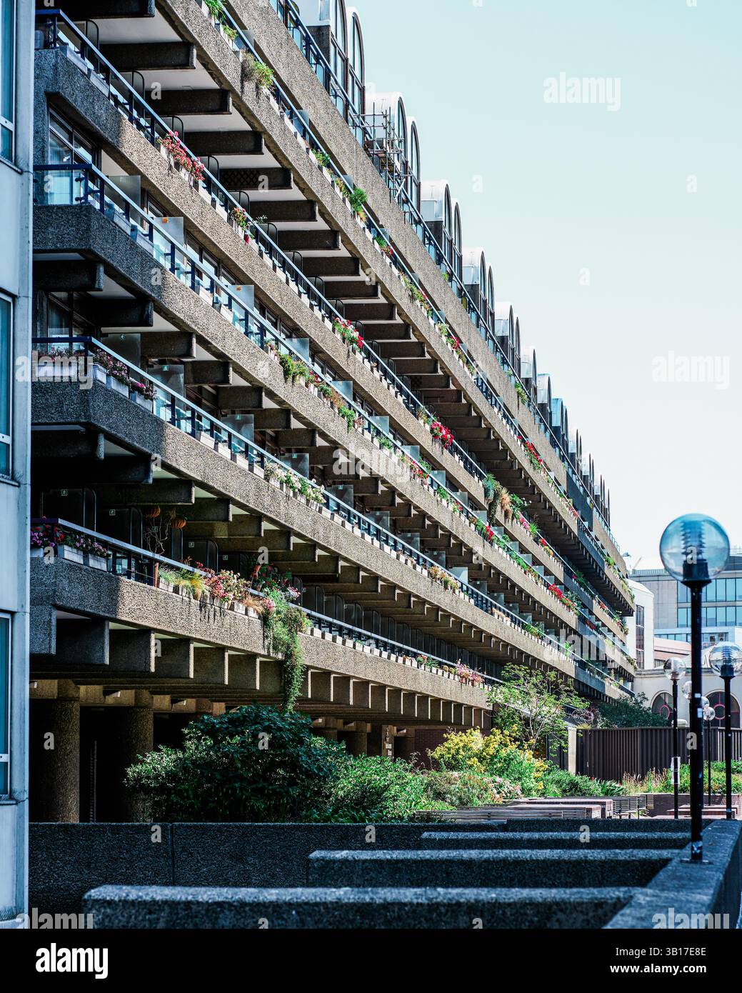 The Barbican Estate's concrete balconies, adorned with plants, rise ...