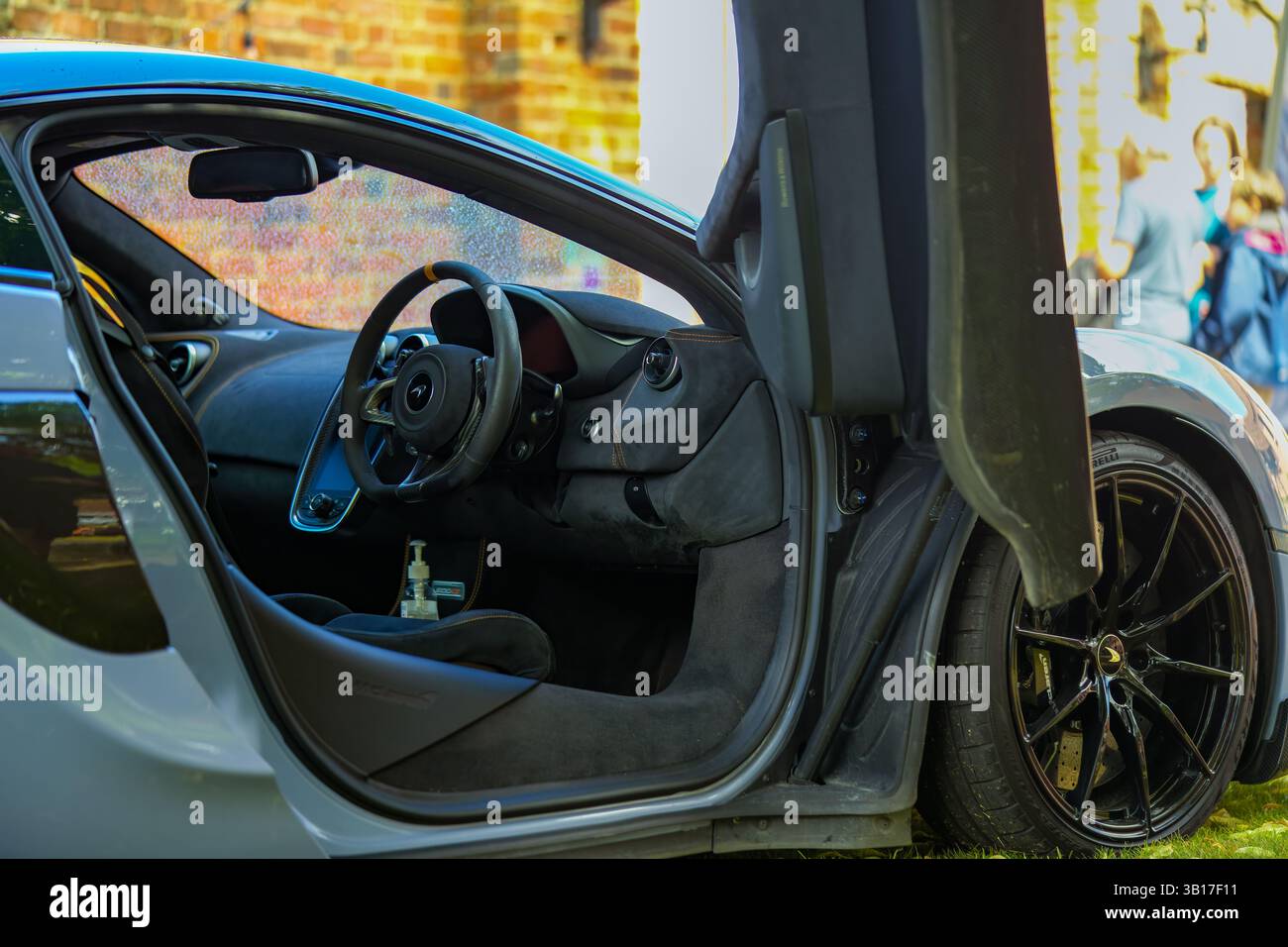 A sleek blue McLaren sports car with open door, showcasing the interior ...