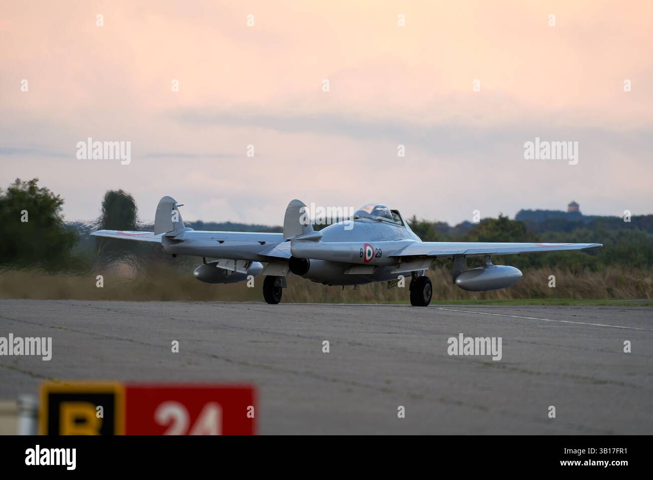 A silver De Havilland Vampire FB.53 fighter jet taxis on a runway at ...