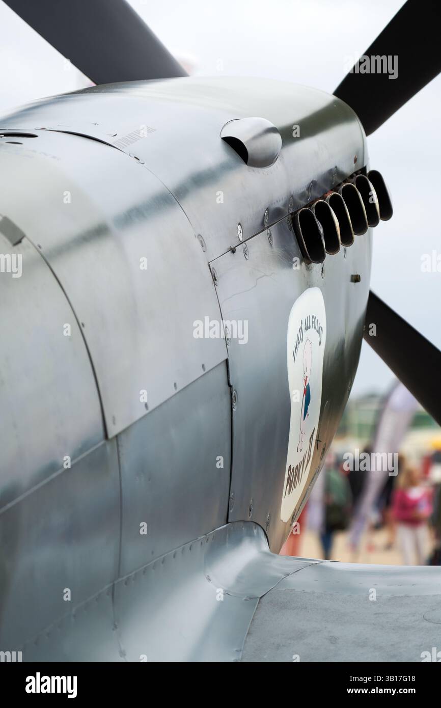 Close-up of an RAF Spitfire's exhaust pipes and insignia at an airshow ...