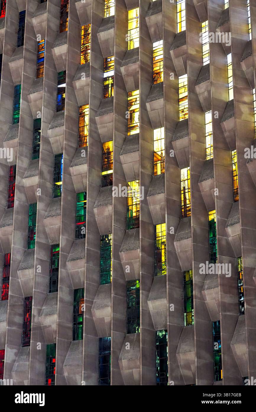 Colorful stained glass windows adorn the modern, concrete facade of ...