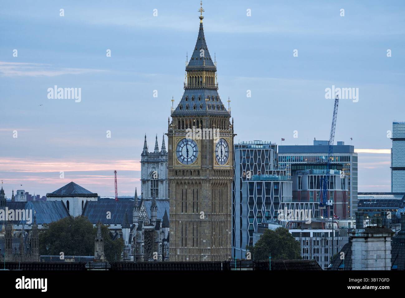 The Elizabeth Tower, housing Big Ben, stands tall against a dusky sky ...