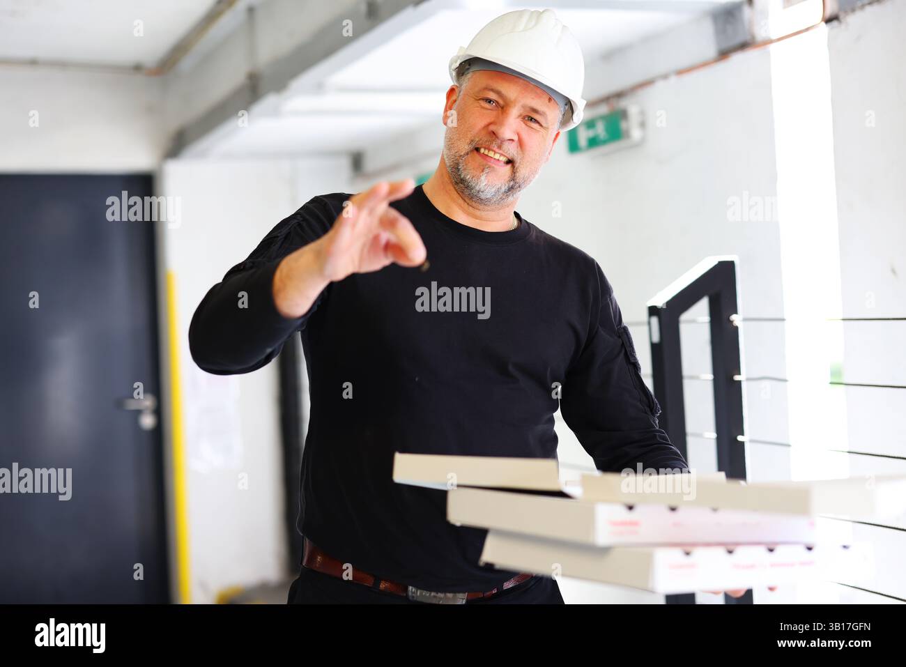 Construction worker holding a small insect with two fingers, focus on ...