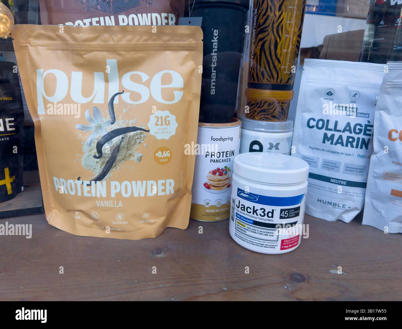 Variety of protein supplements displayed in a store window inviting ...