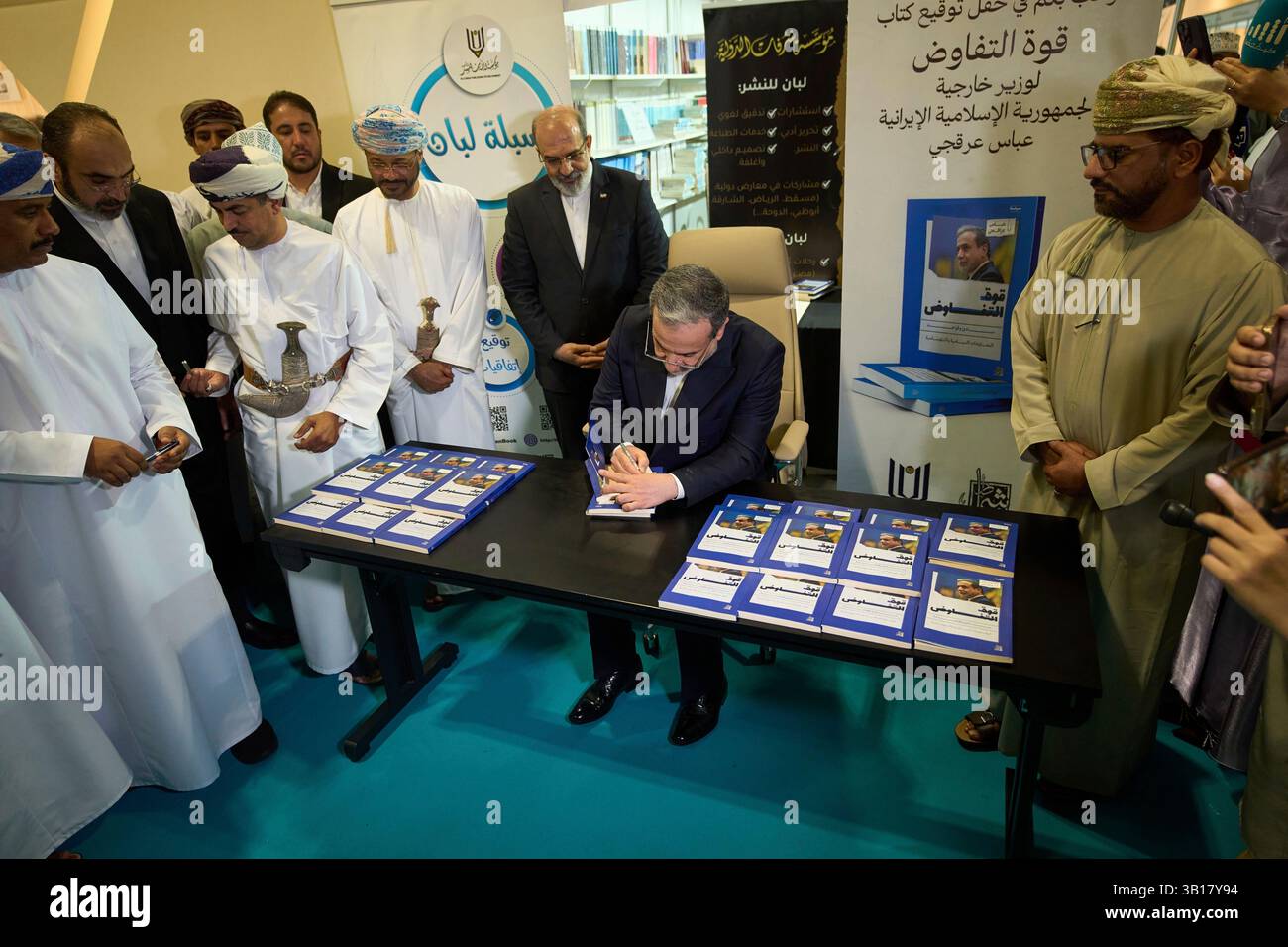 Iranian Foreign Minister Abbas Araghchi, signs copies of his book "The ...