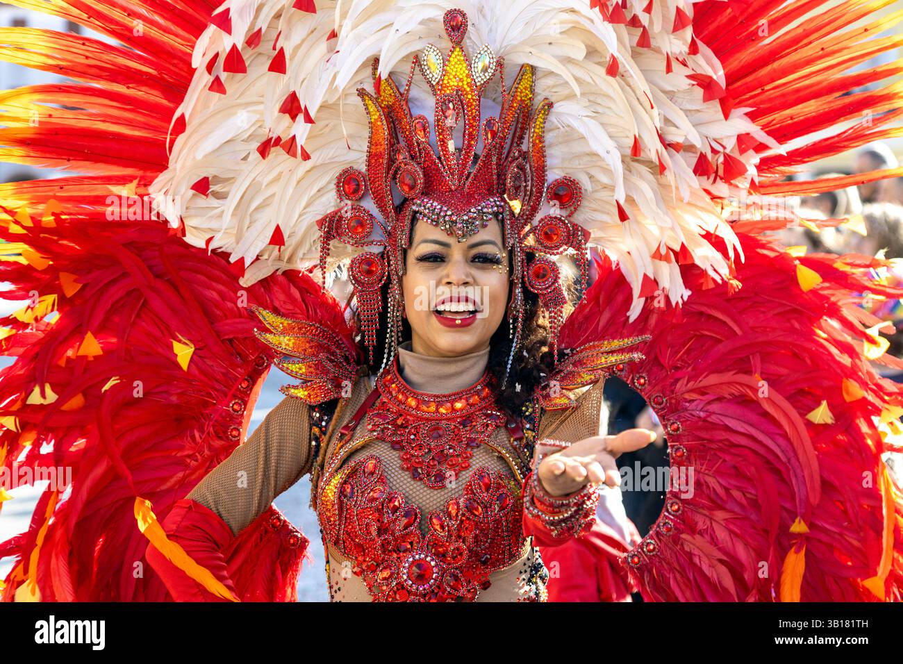 Piove di Sacco, Padua, Italy - Mar 16th, 2025: Smiling Brazilian samba dancer in vibrant red ...