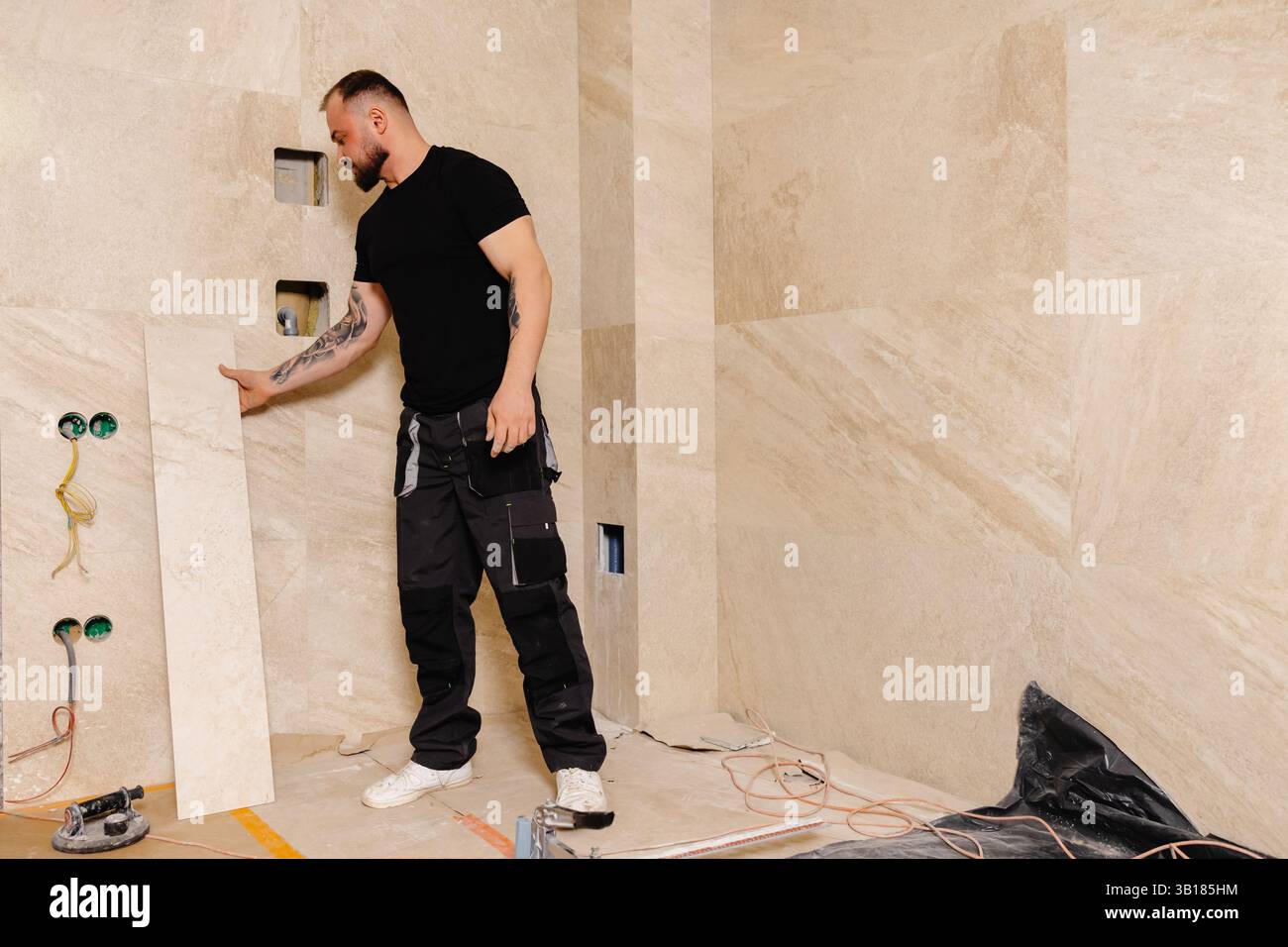 Tiler placing large format marble hi-res stock photography and images ...
