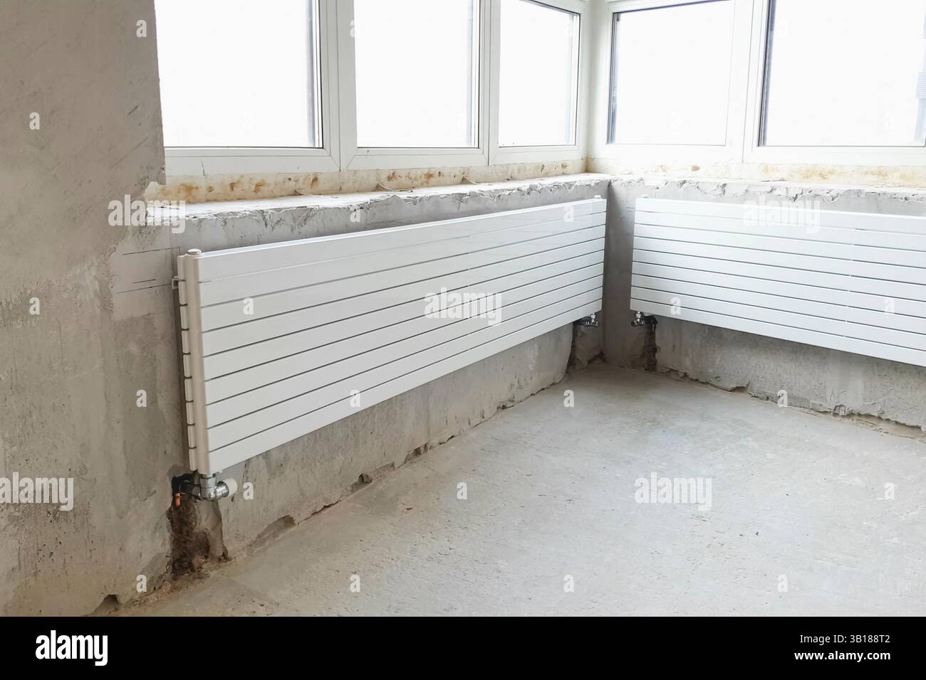 White radiators of the heating system. New building house, heating ...