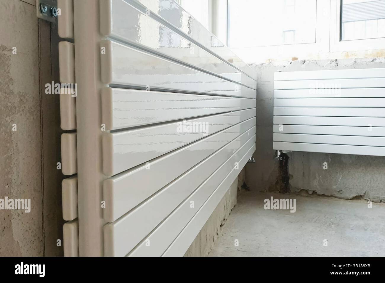White radiators of the heating system. New building house, heating ...
