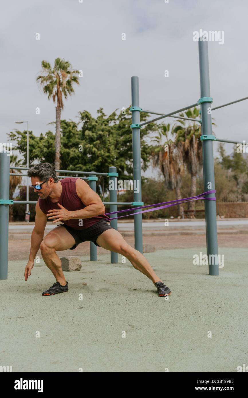 Vertical photo of an athlete training outdoors in a tropical location ...