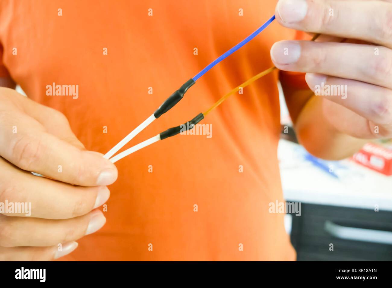 Stripping the ends of wires and connecting them Stock Photo - Alamy